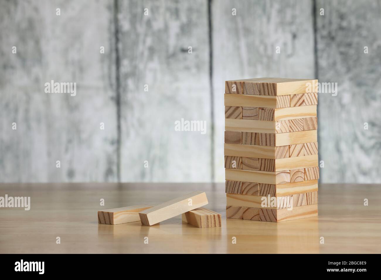 wooden bricks on a table. Tower construction game Stock Photo - Alamy