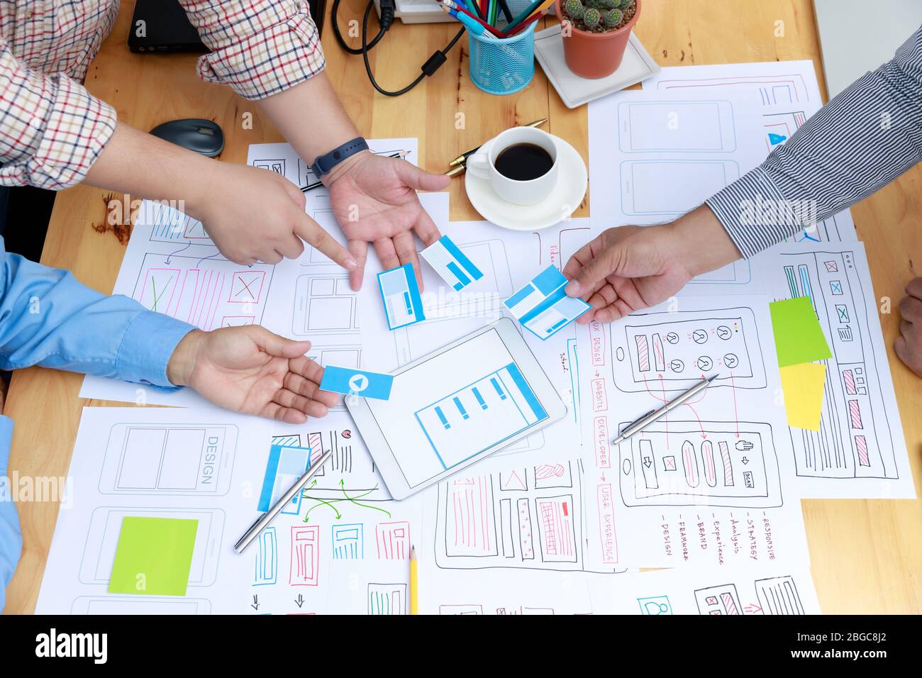 Graphic designers work together with UX UI designer planning ...
