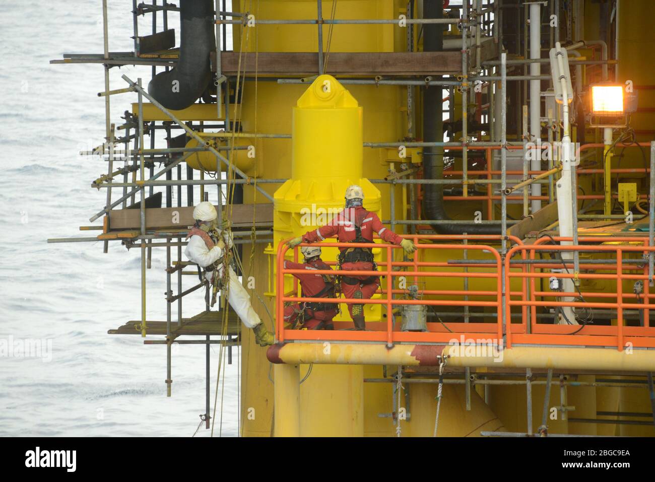 maintenance crew installing scafolding before start maintenance at oil ...