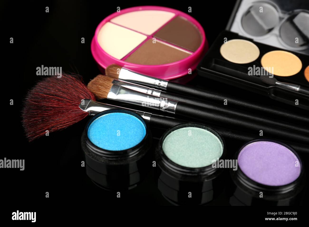 Bright eye shadows on black background Stock Photo - Alamy