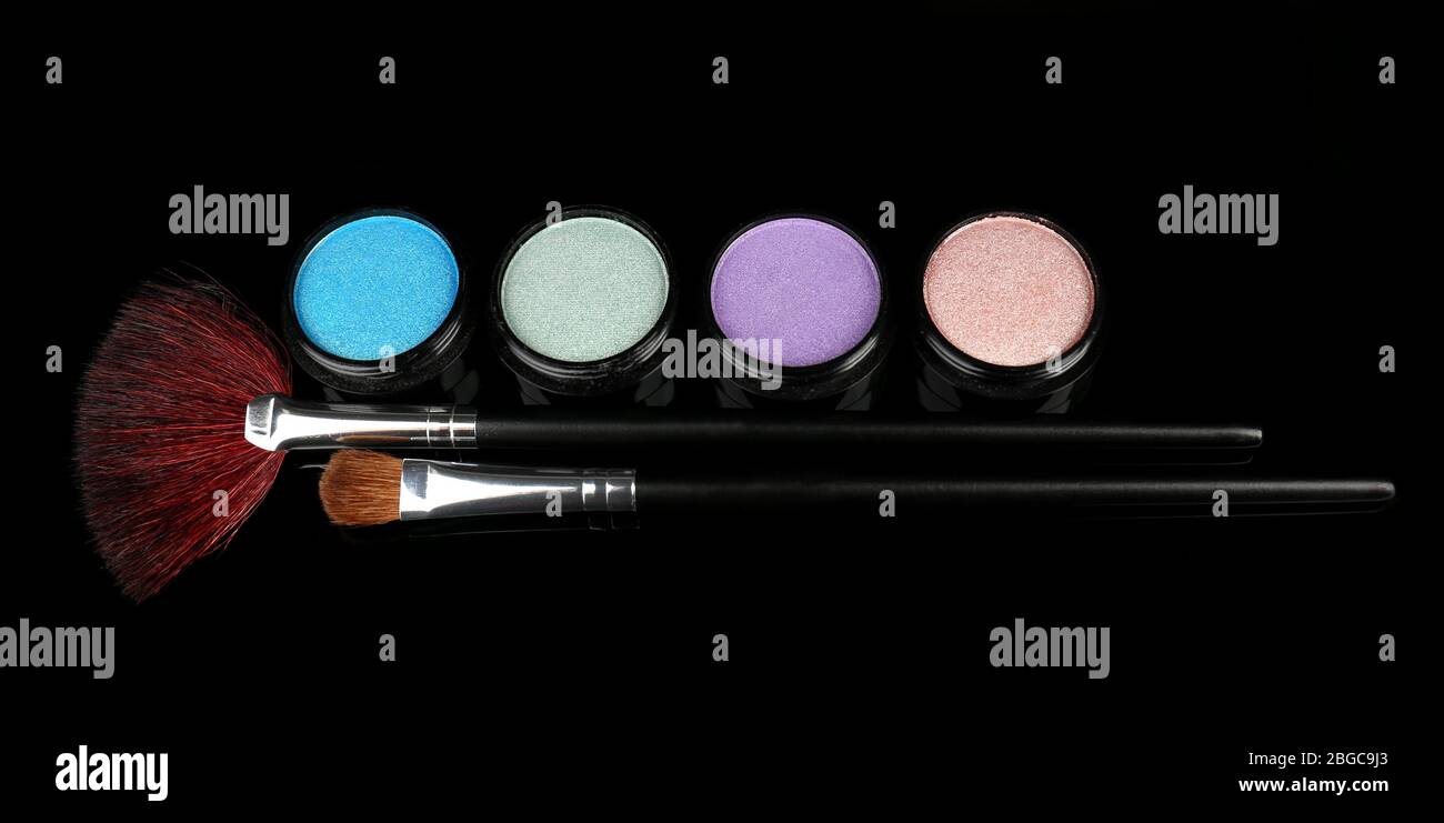Bright eye shadows on black background Stock Photo - Alamy