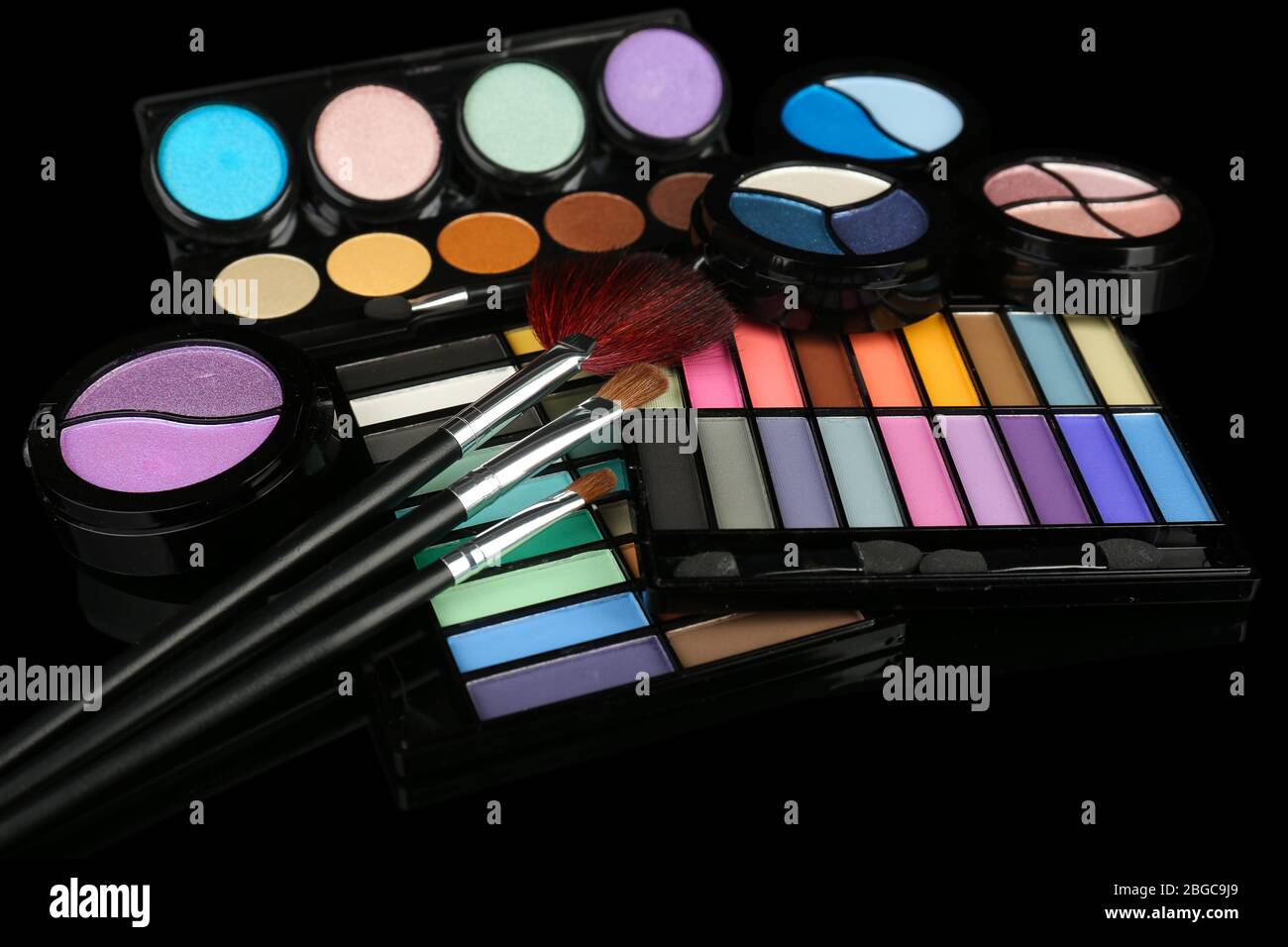 Bright eye shadows on black background Stock Photo - Alamy