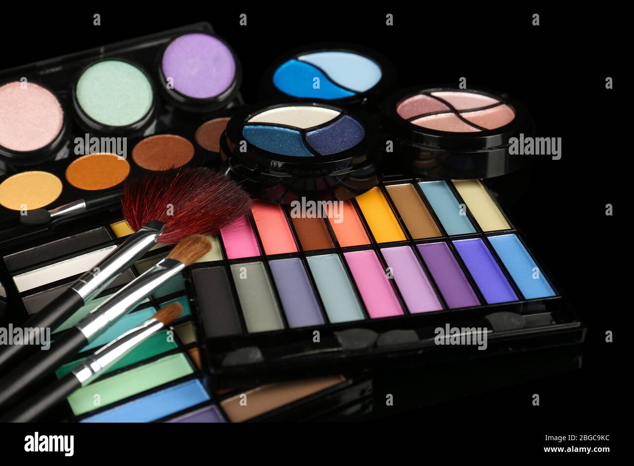 Bright eye shadows on black background Stock Photo - Alamy