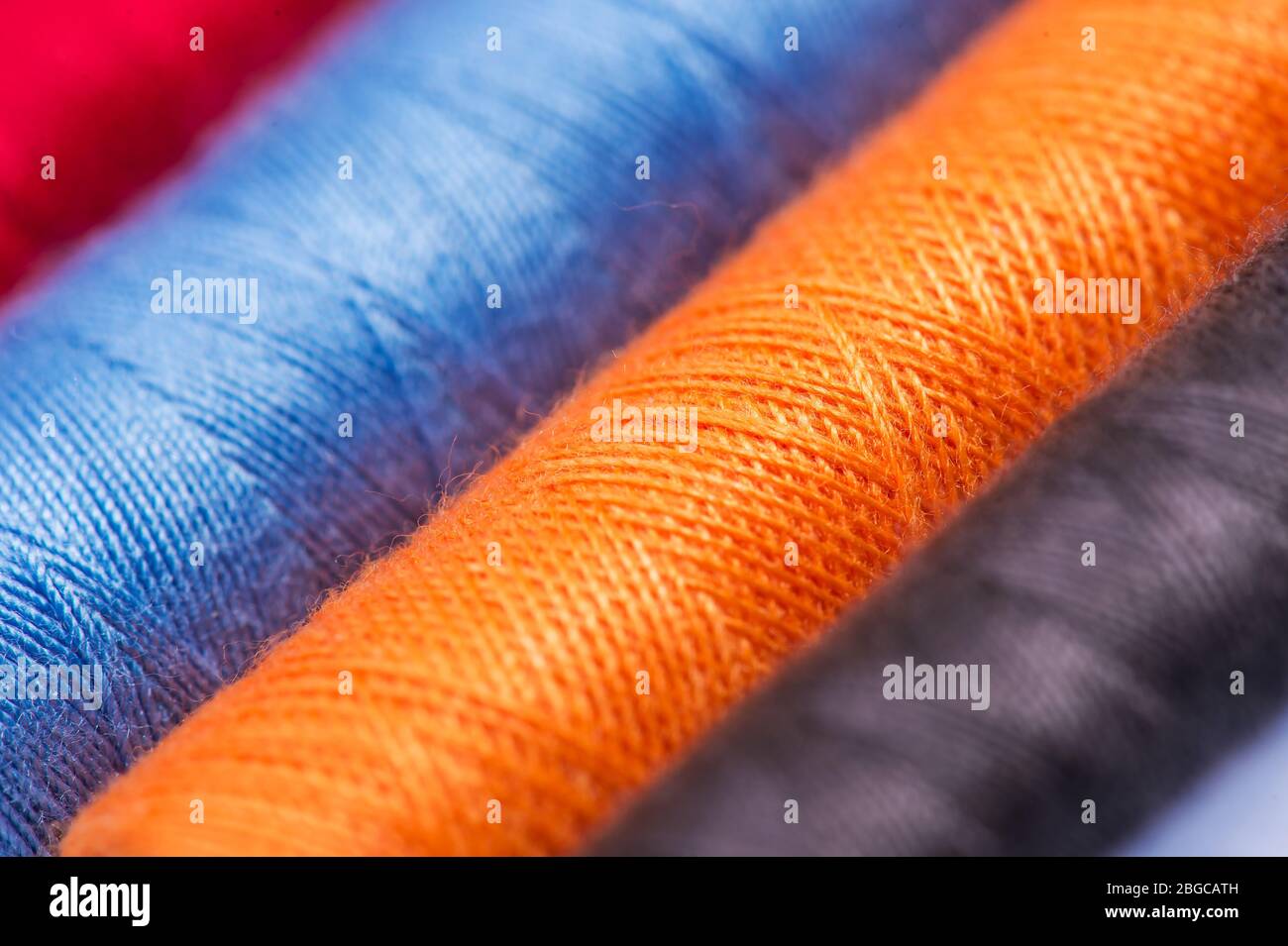 Close up photo of multicolor sewing threads Stock Photo - Alamy