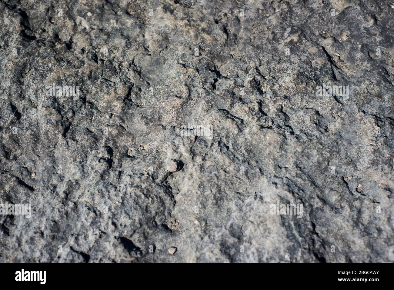 Grey textured stone background in breakwater Stock Photo - Alamy