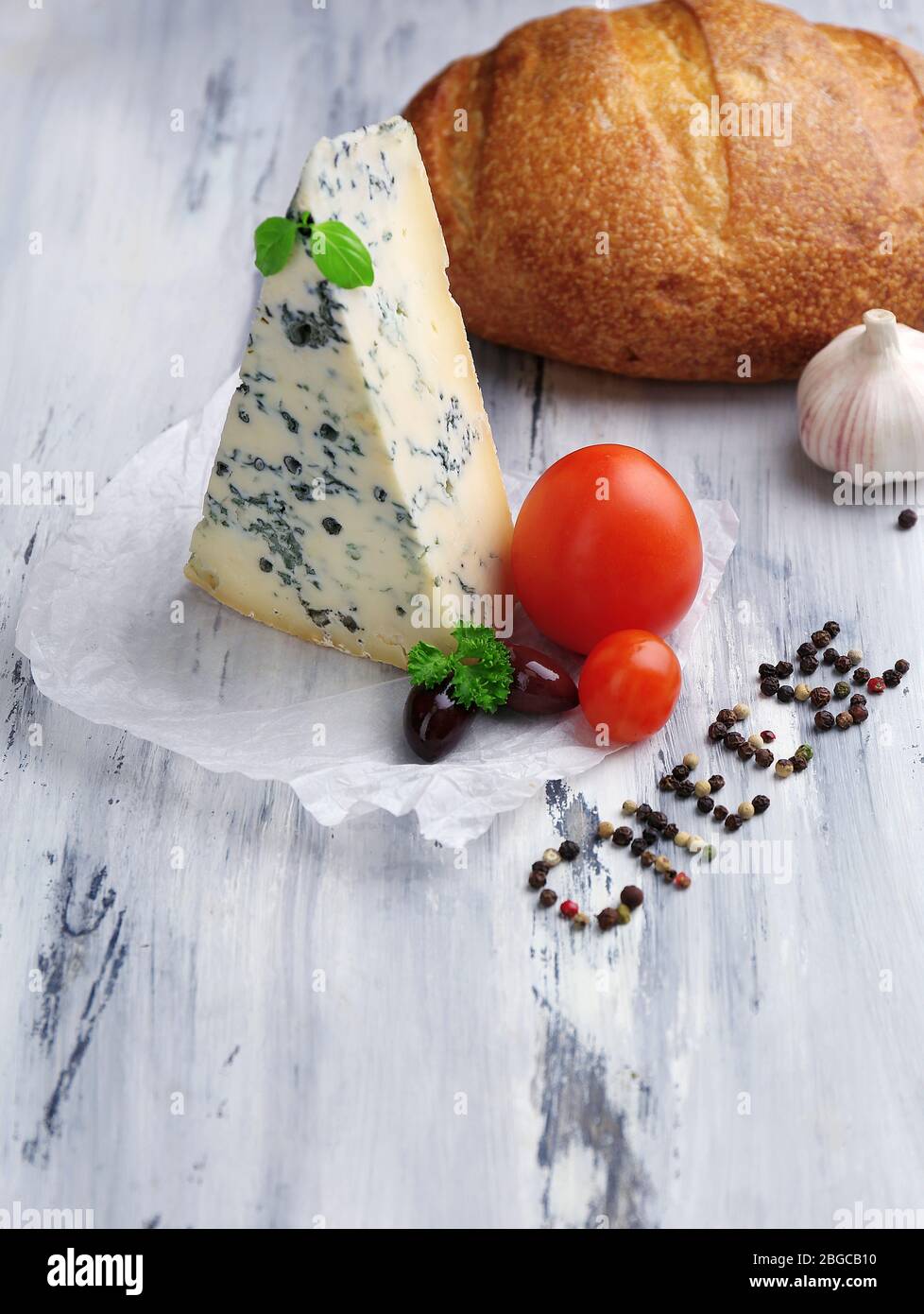 Tasty blue cheese and bread on old wooden table Stock Photo - Alamy
