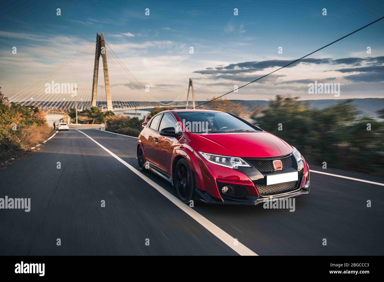 Red chasing car on the mountain road in sunny weather Stock Photo - Alamy