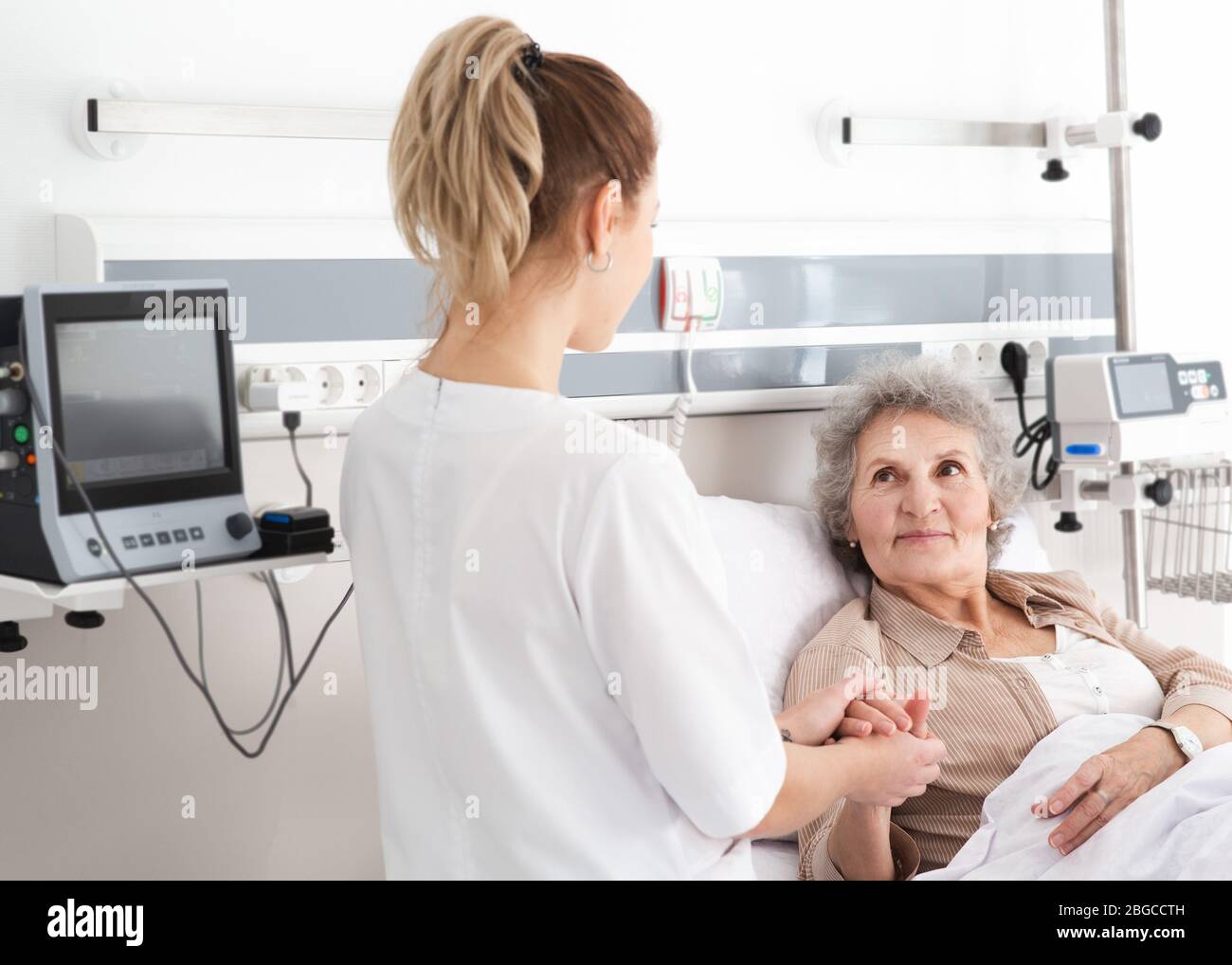elderly woman in a hospital ward receives nursing care. Recovery after ...