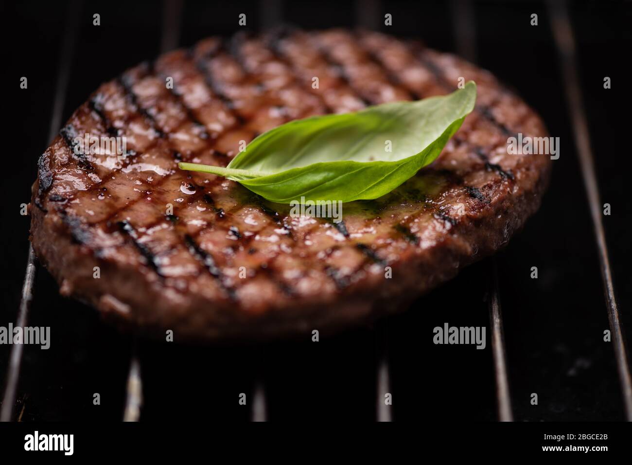 A beef burger grill cooking close up Stock Photo - Alamy