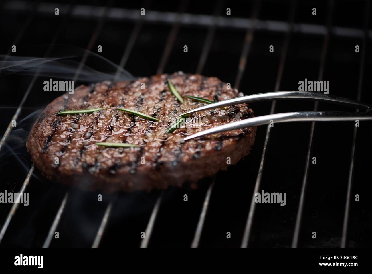A beef burger grill cooking close up Stock Photo - Alamy