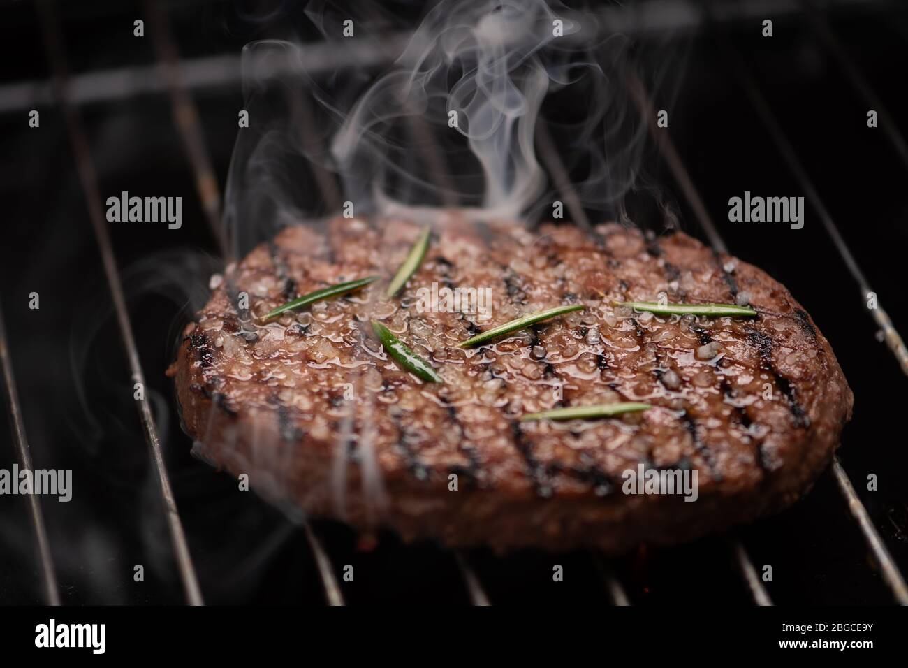 A beef burger grill cooking close up Stock Photo - Alamy
