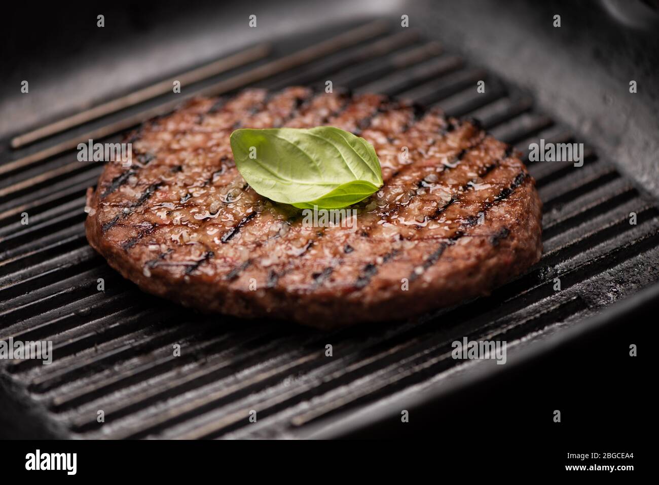 A beef burger grill cooking close up Stock Photo - Alamy