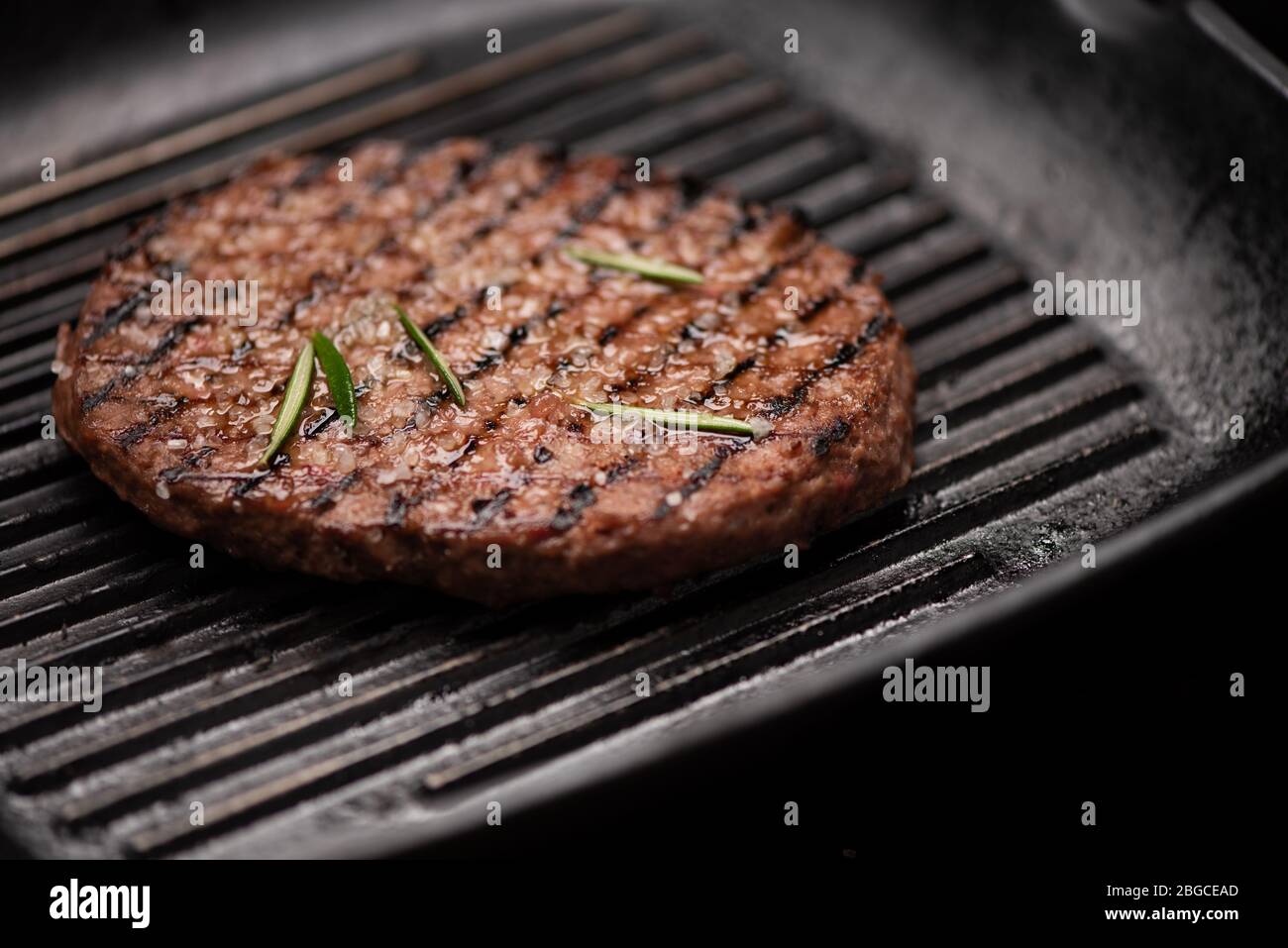 A beef burger grill cooking close up Stock Photo - Alamy