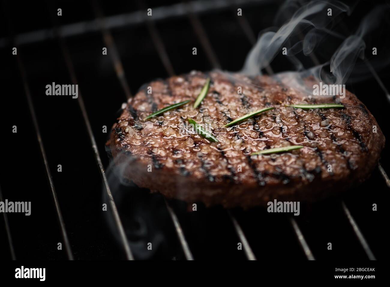 A beef burger grill cooking close up Stock Photo - Alamy