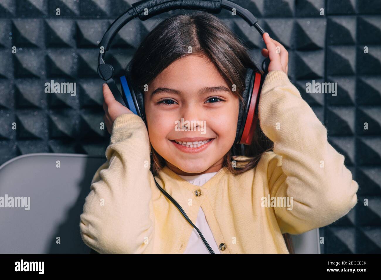 Cute little mixed race child while procedure hearing exam. Girl wearing ...