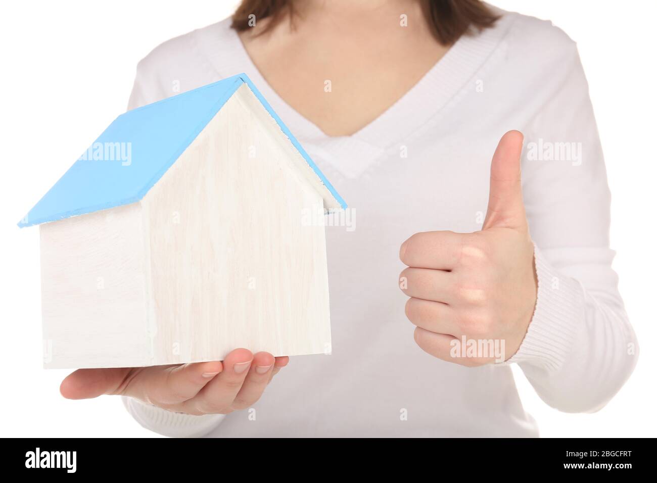 Small wooden house in hands isolated on white Stock Photo - Alamy