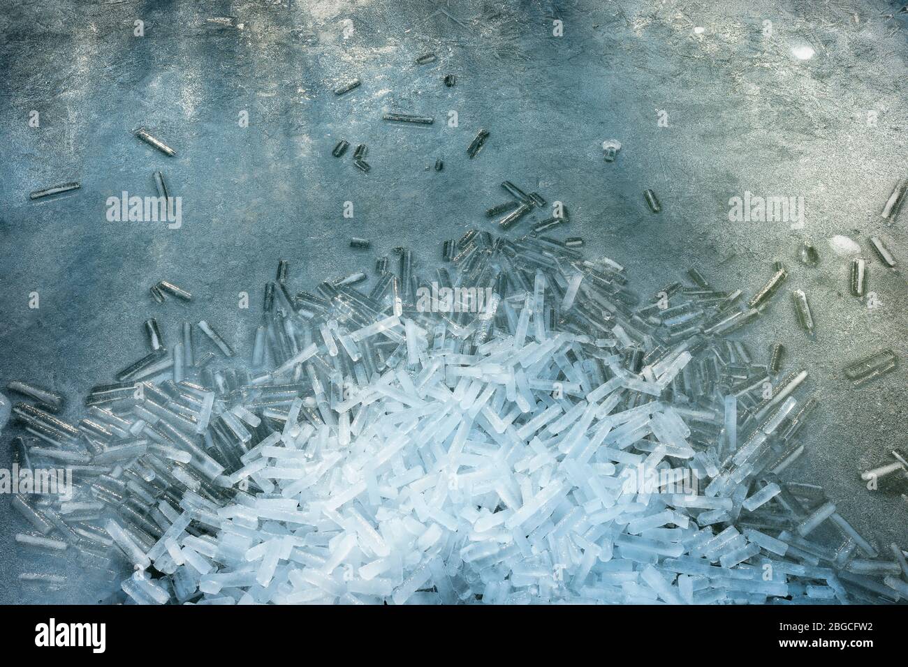 Chunks of ice on a frozen lake hit by the first sunbeams of a cold ...