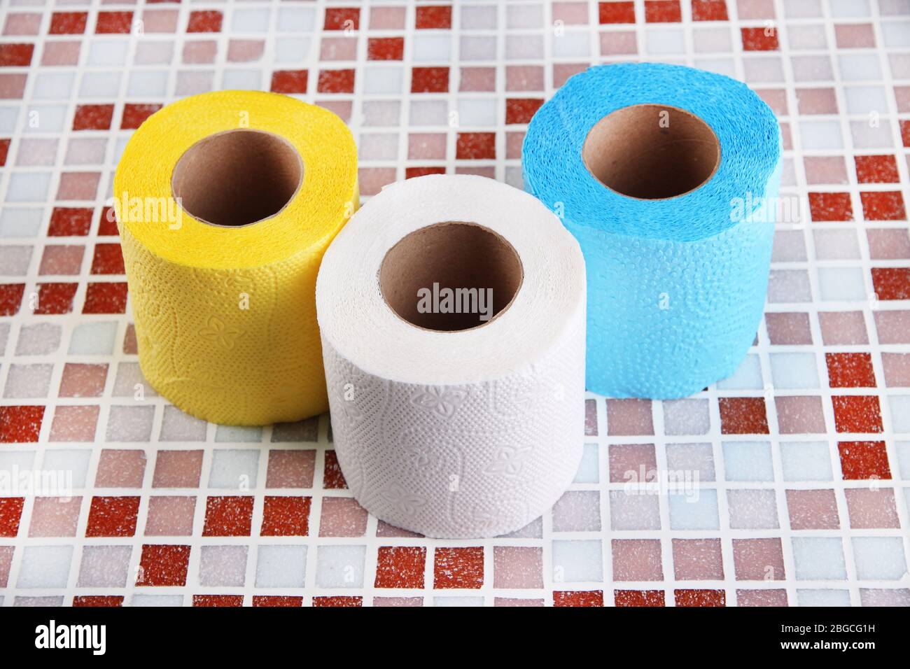 Color toilet paper rolls on bright background Stock Photo - Alamy