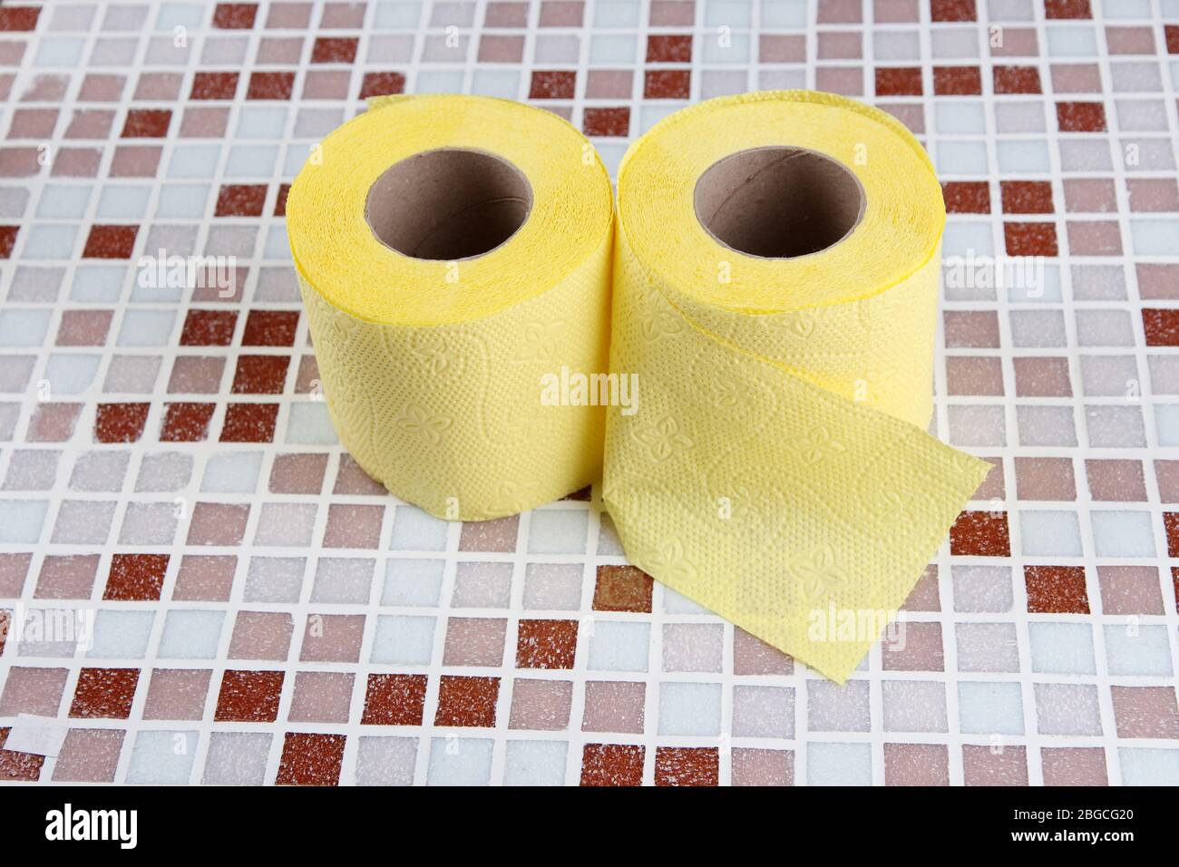 Color toilet paper rolls on bright background Stock Photo - Alamy