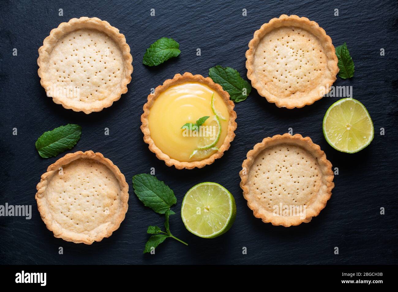 Food concept Homemade organic Lemon, lime tarts or mini pie on black ...