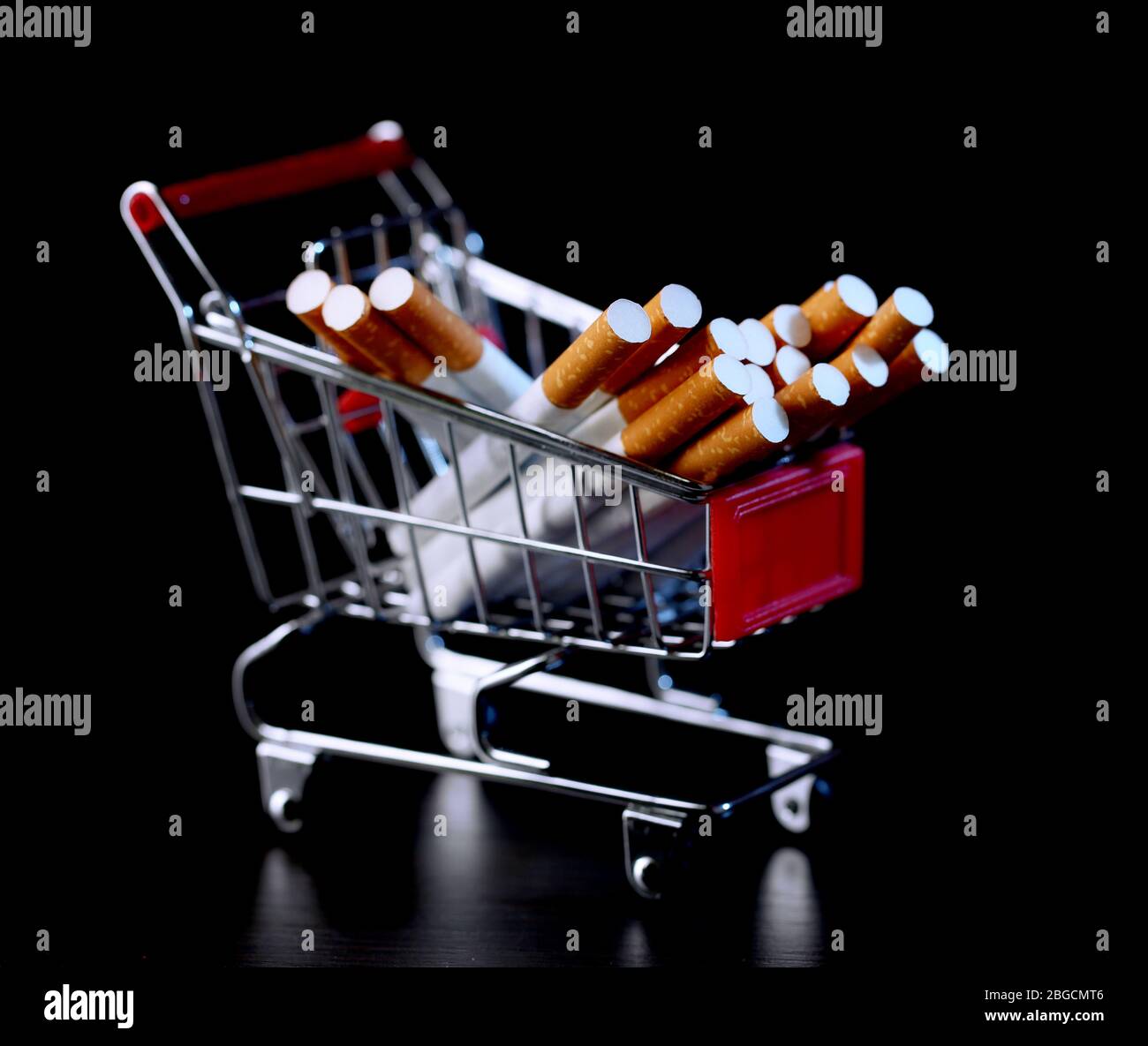 Cigarettes in shopping cart on wooden table on dark background Stock ...