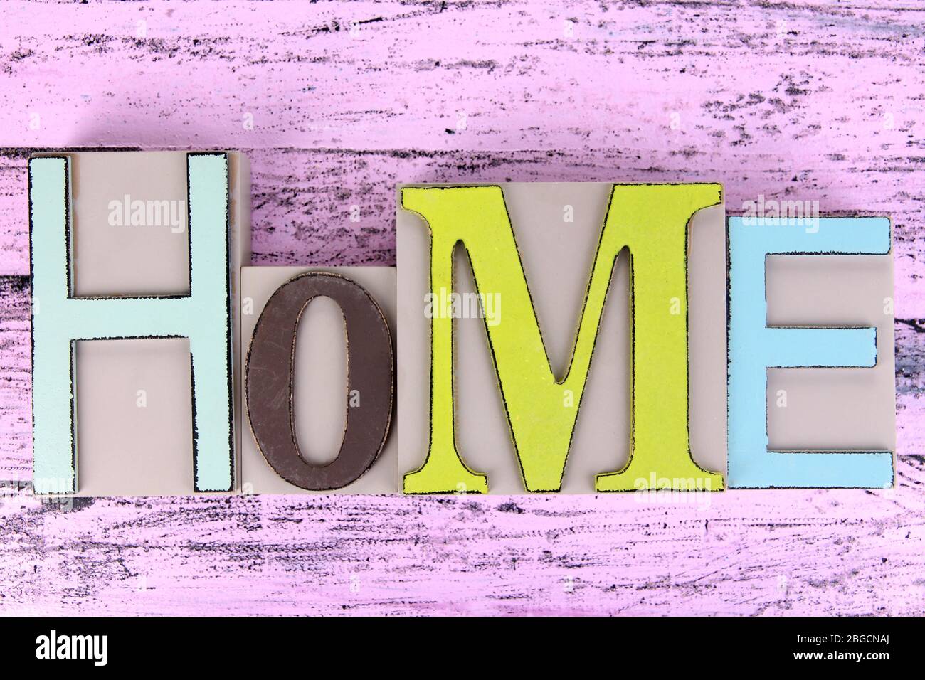 Decorative letters forming word HOME on wooden background Stock Photo ...