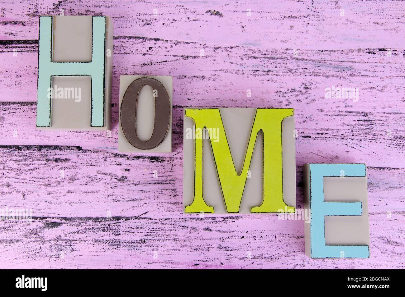 Decorative letters forming word HOME on wooden background Stock Photo ...