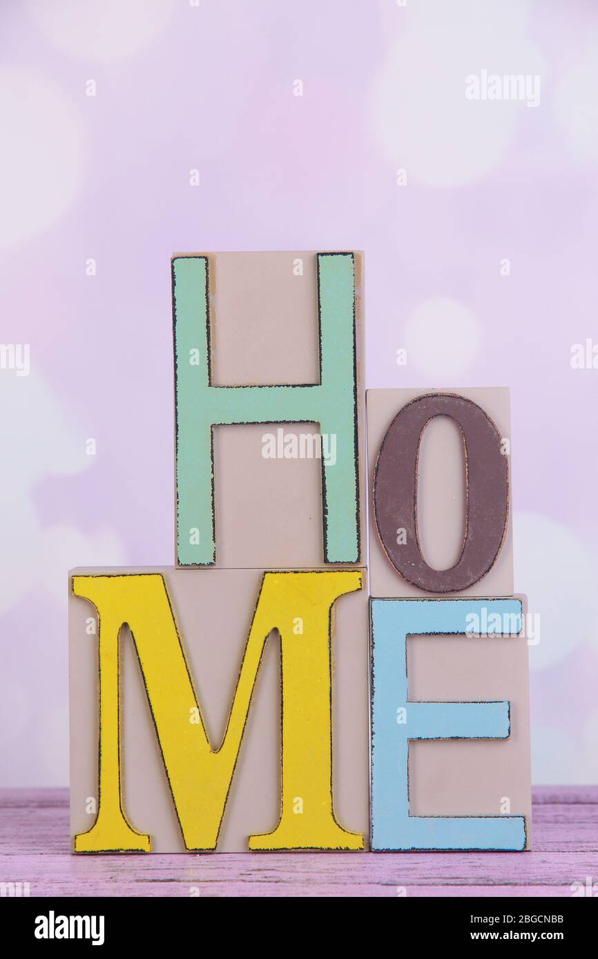 Decorative letters forming word HOME on table on bright background ...