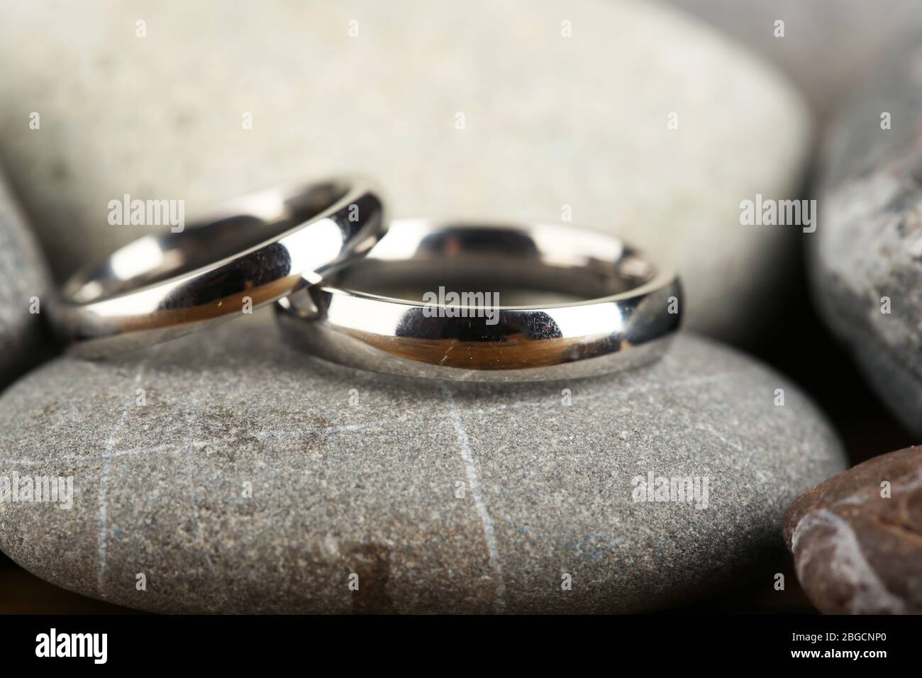 Wedding rings on rocks close-up Stock Photo - Alamy