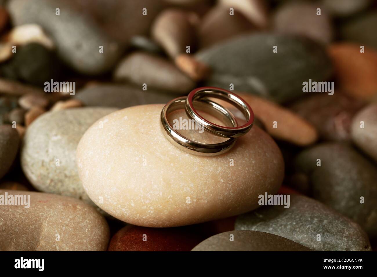 Wedding rings on rocks close-up Stock Photo - Alamy
