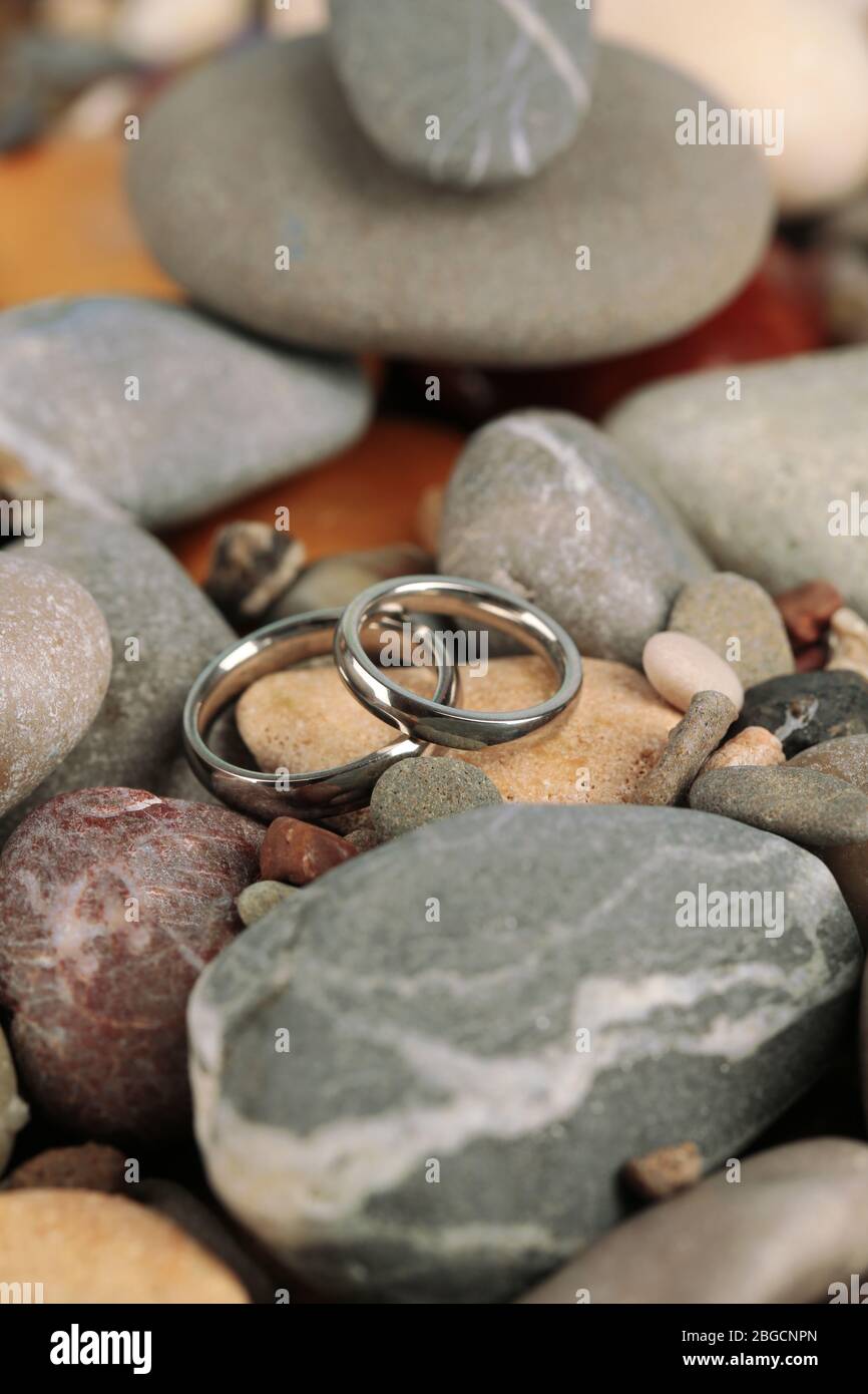Wedding rings on rocks close-up Stock Photo - Alamy