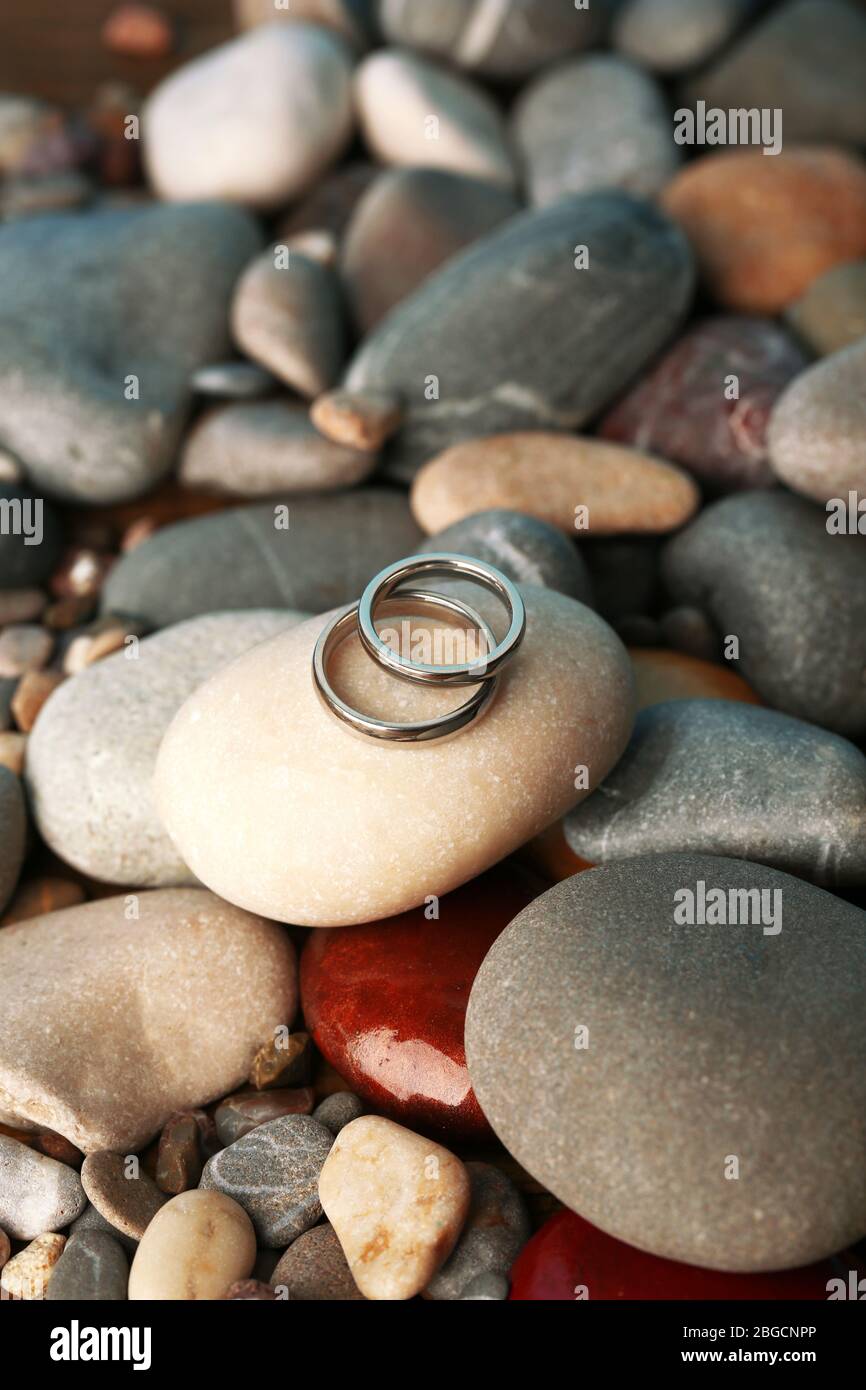 Wedding rings on rocks close-up Stock Photo - Alamy