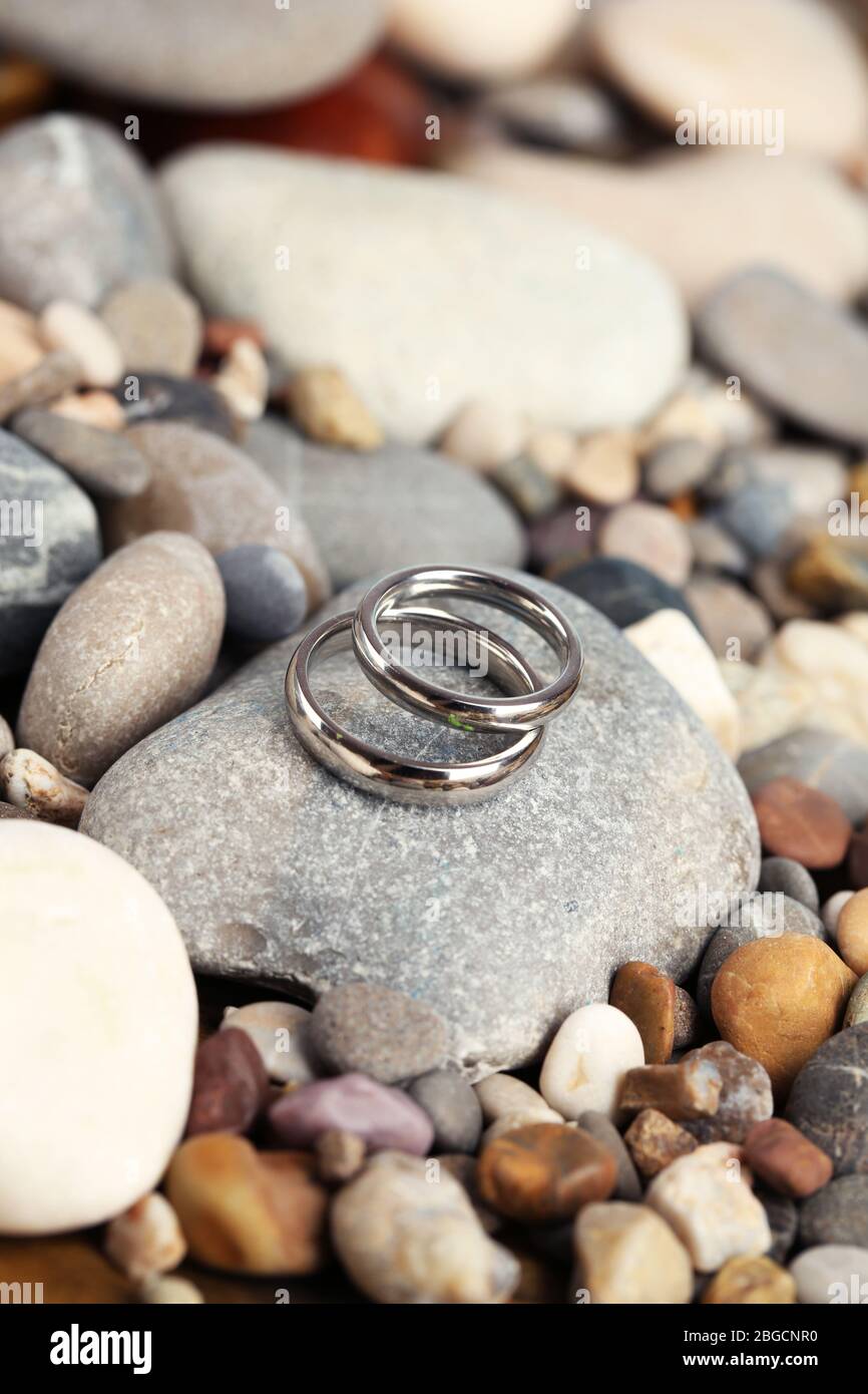 Wedding rings on rocks close-up Stock Photo - Alamy