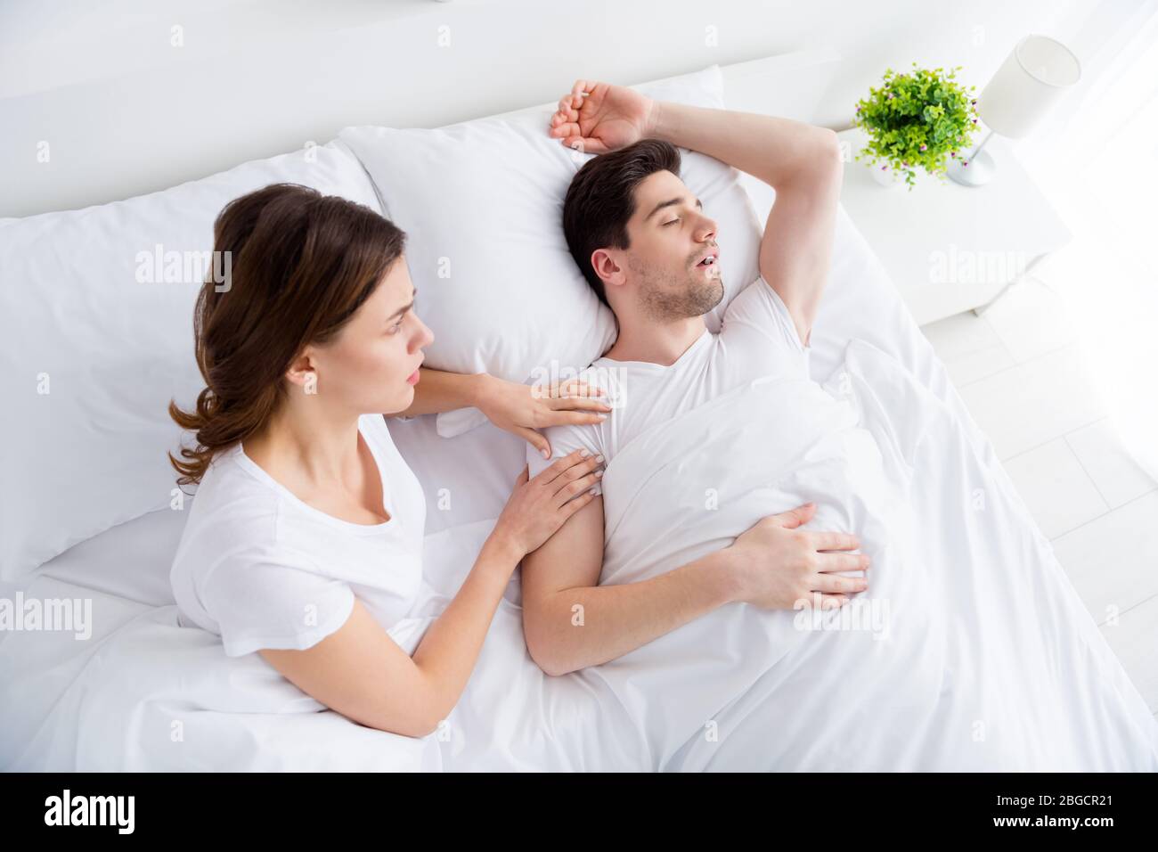 Honey you are snoring. High angle above photo of irritated lady waking ...