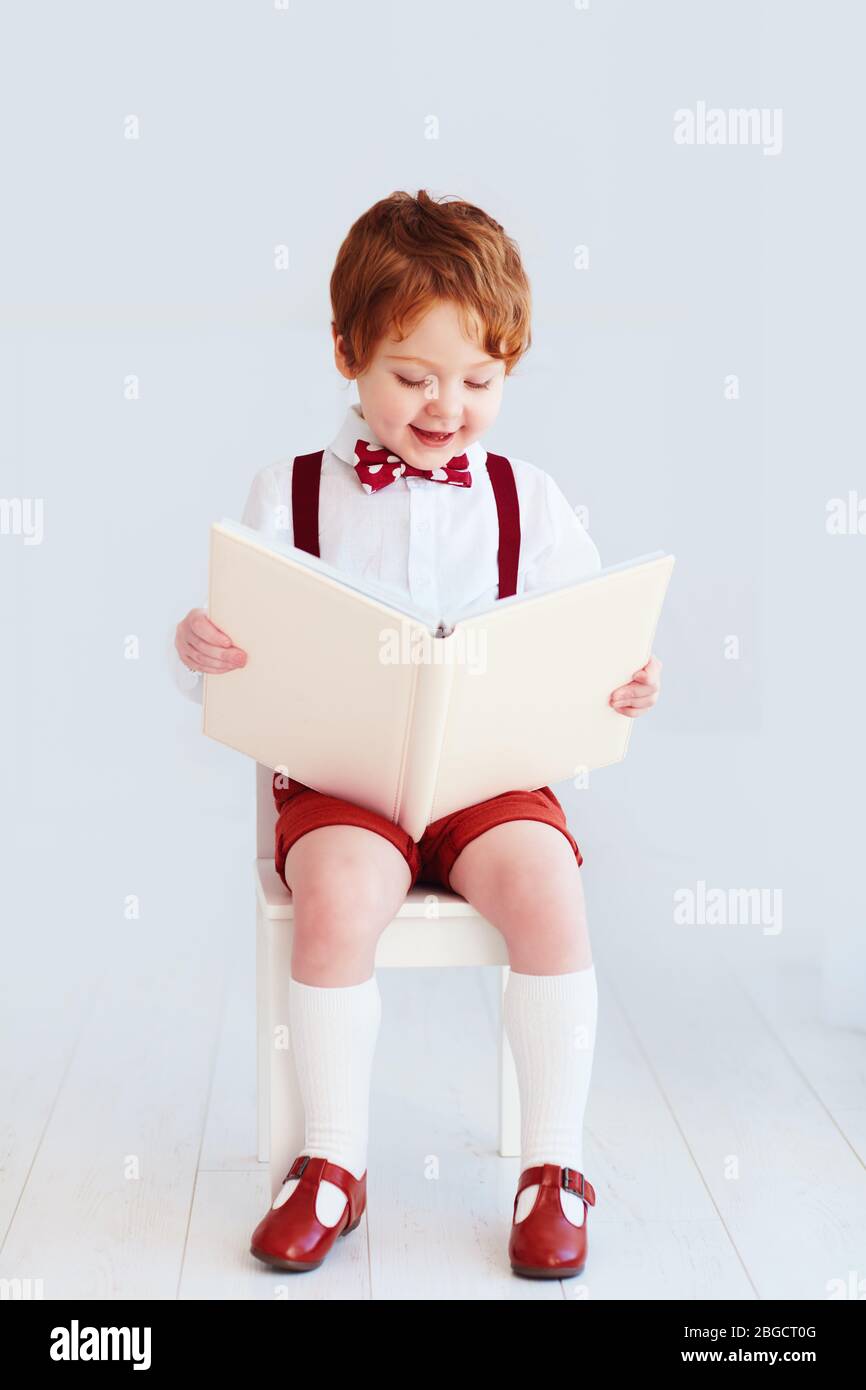 cute happy toddler baby boy reading book Stock Photo - Alamy