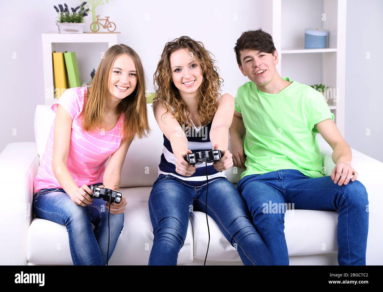 Group of young friends playing video games at home Stock Photo - Alamy