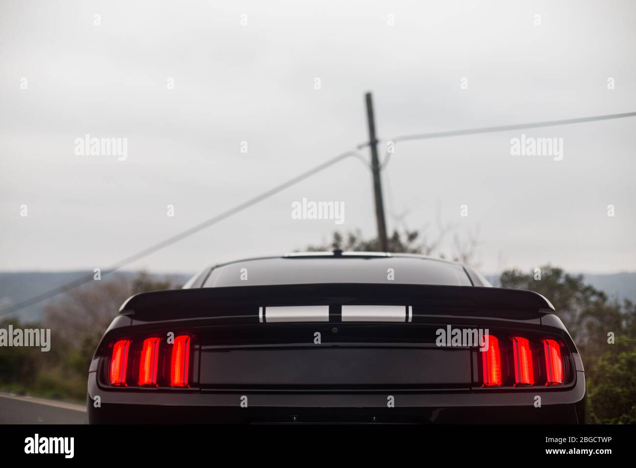 Back red xenon lights of a black car Stock Photo - Alamy