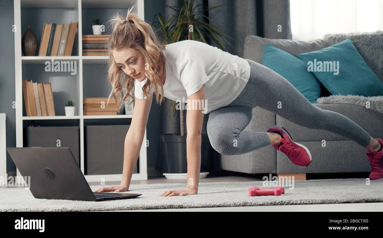 Girl doing high plank crunches Stock Photo - Alamy