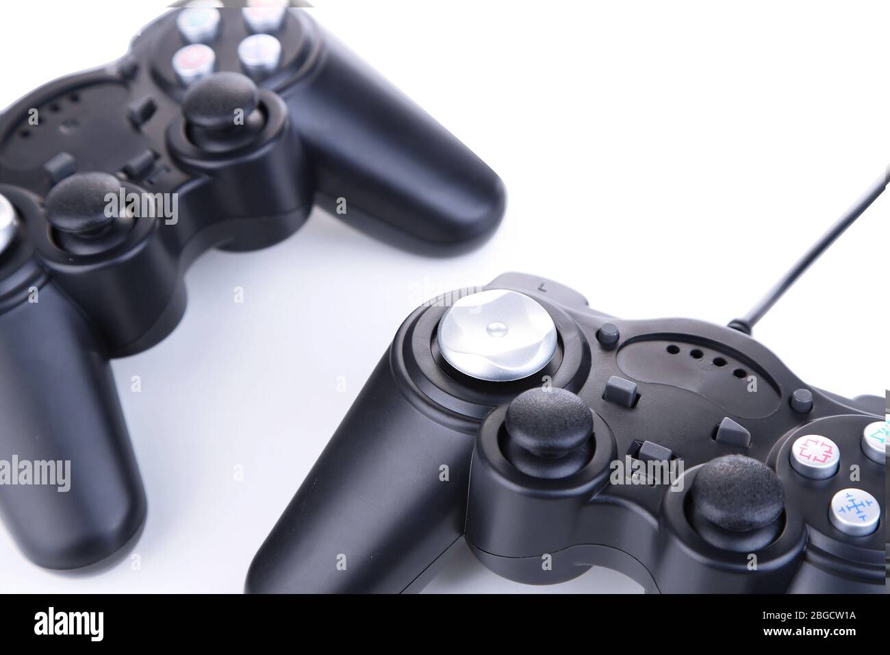 Black game controllers isolated on white Stock Photo - Alamy