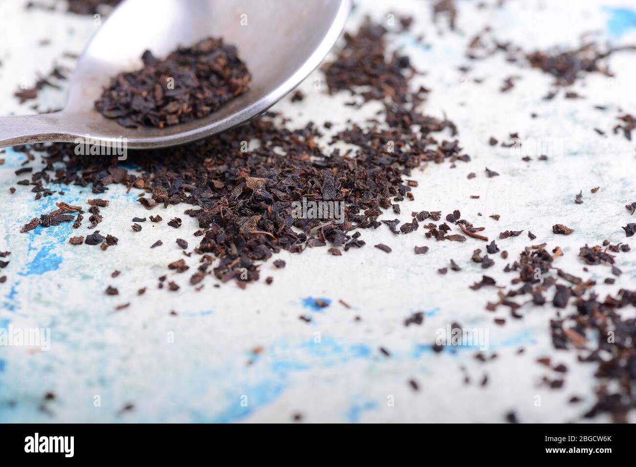 Black tea in a spoon on a white background. Close up shot Stock Photo ...