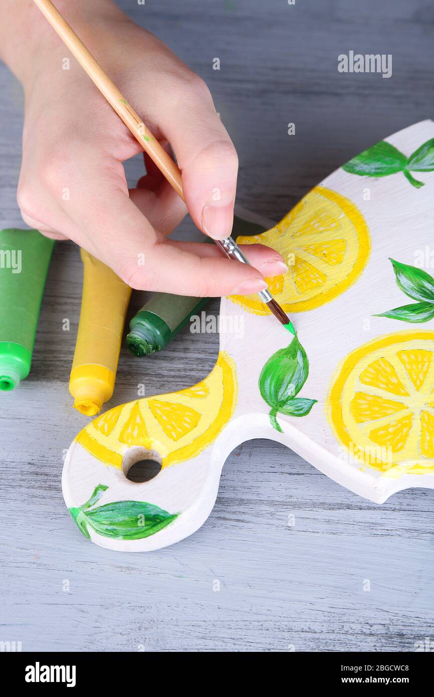 Hand paints on hand made cutting board and art materials Stock Photo ...