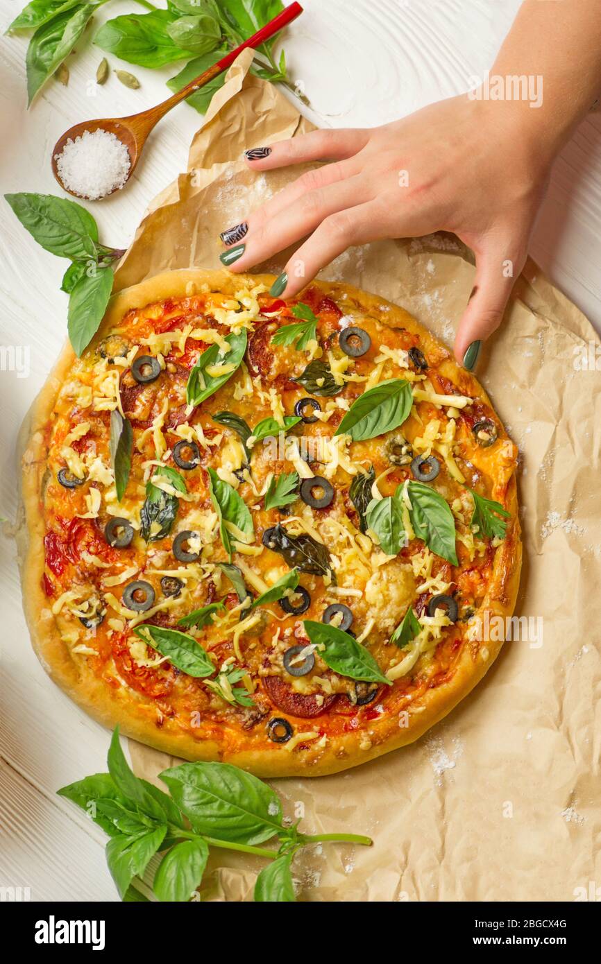 Hand taking pizza slices from white wooden background. Pizza and hand ...