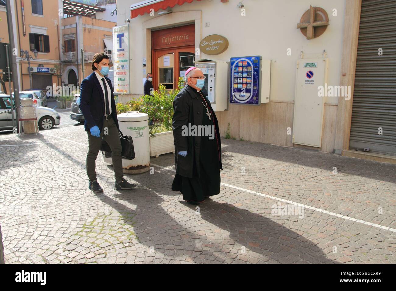 Bishop Joseph Judge with his assistant arrive with a mask and gloves ...