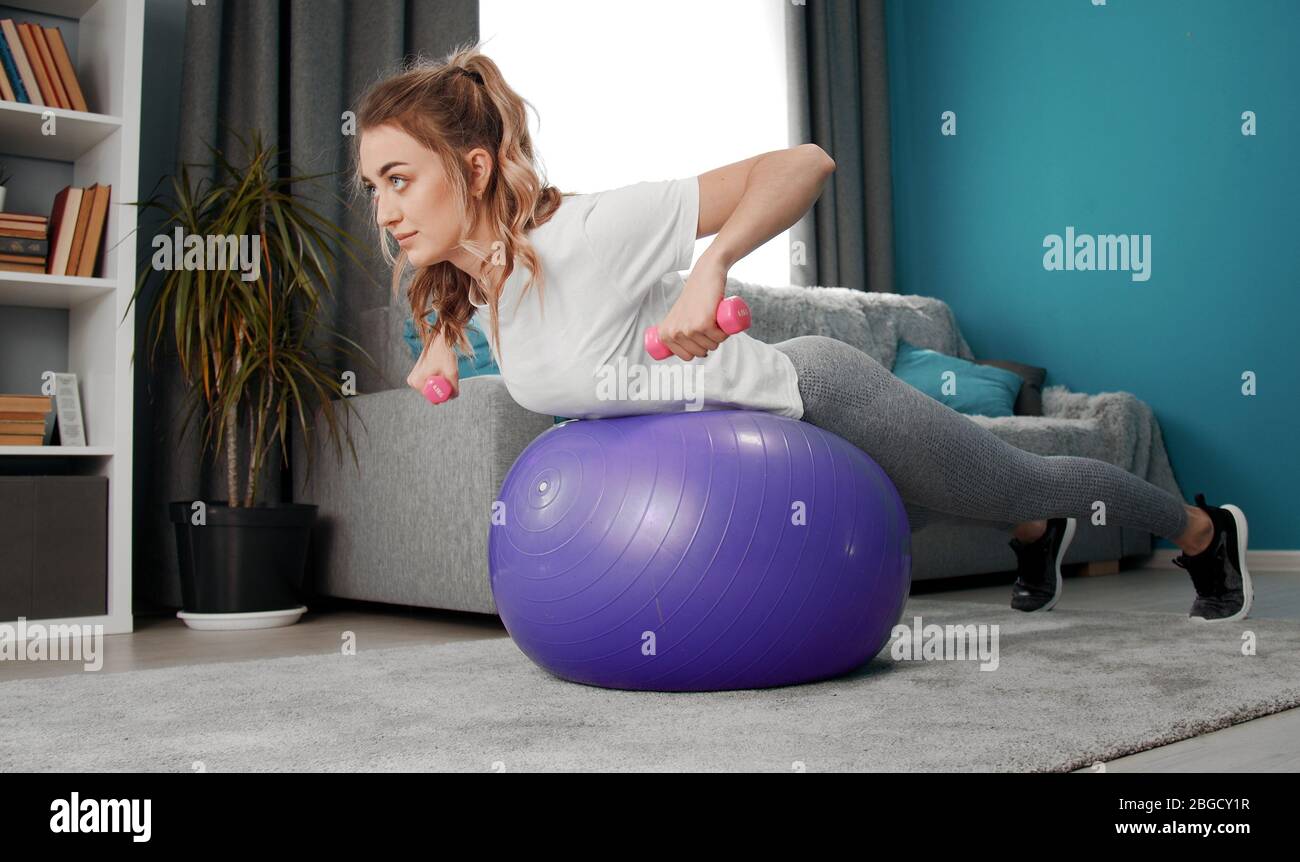 Girl balancing on fitness ball Stock Photo - Alamy