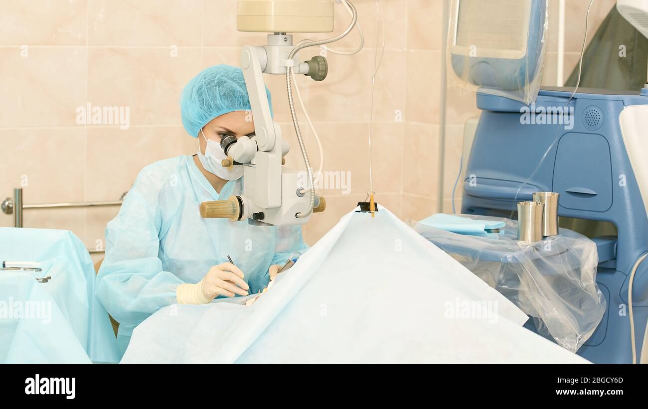 Ophthalmology laser microscope operation. Doctor in clinic. Patient eye ...