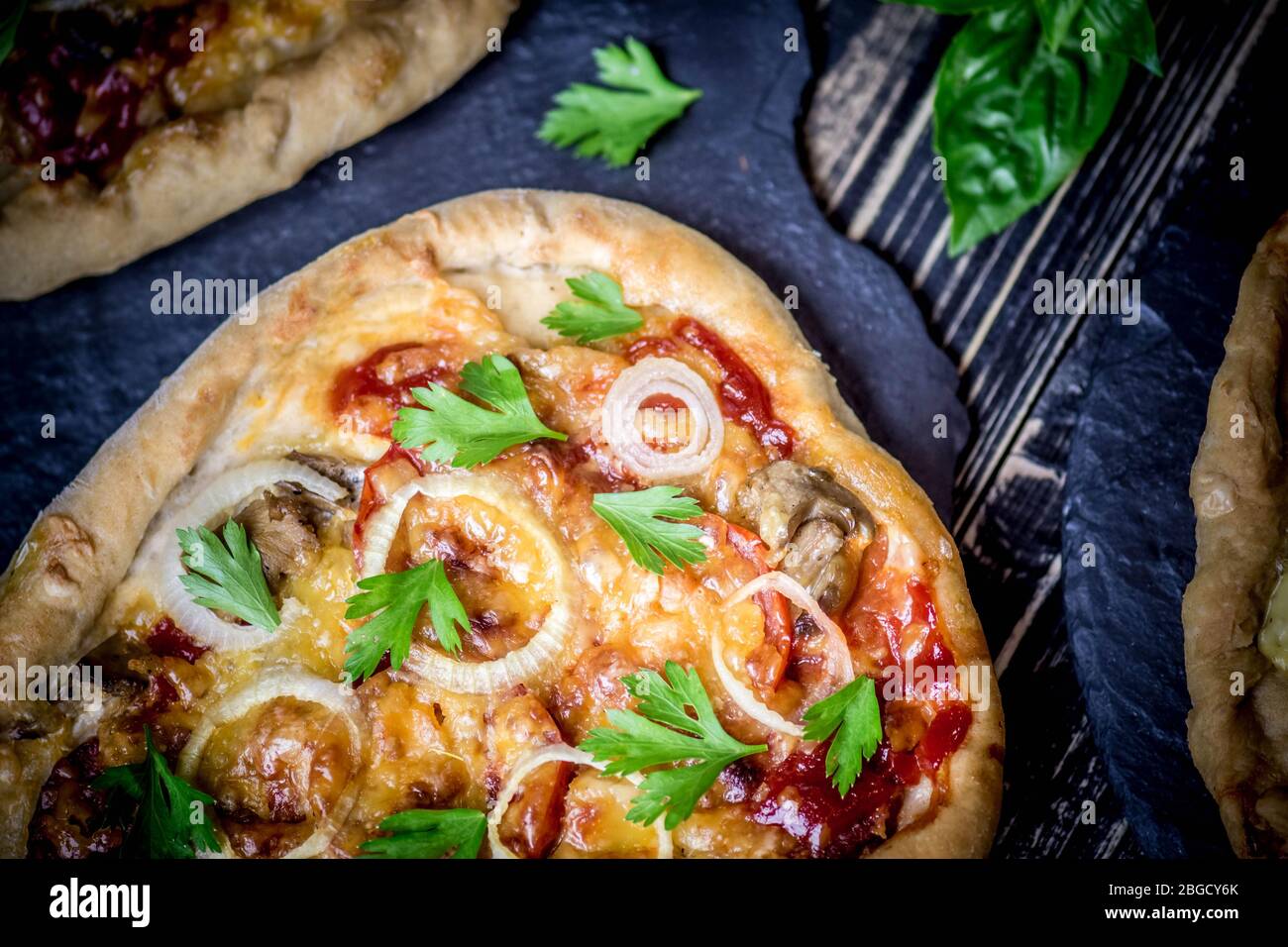 American pizza with mozzarella, tomato, pepperoni on dark wooden table ...