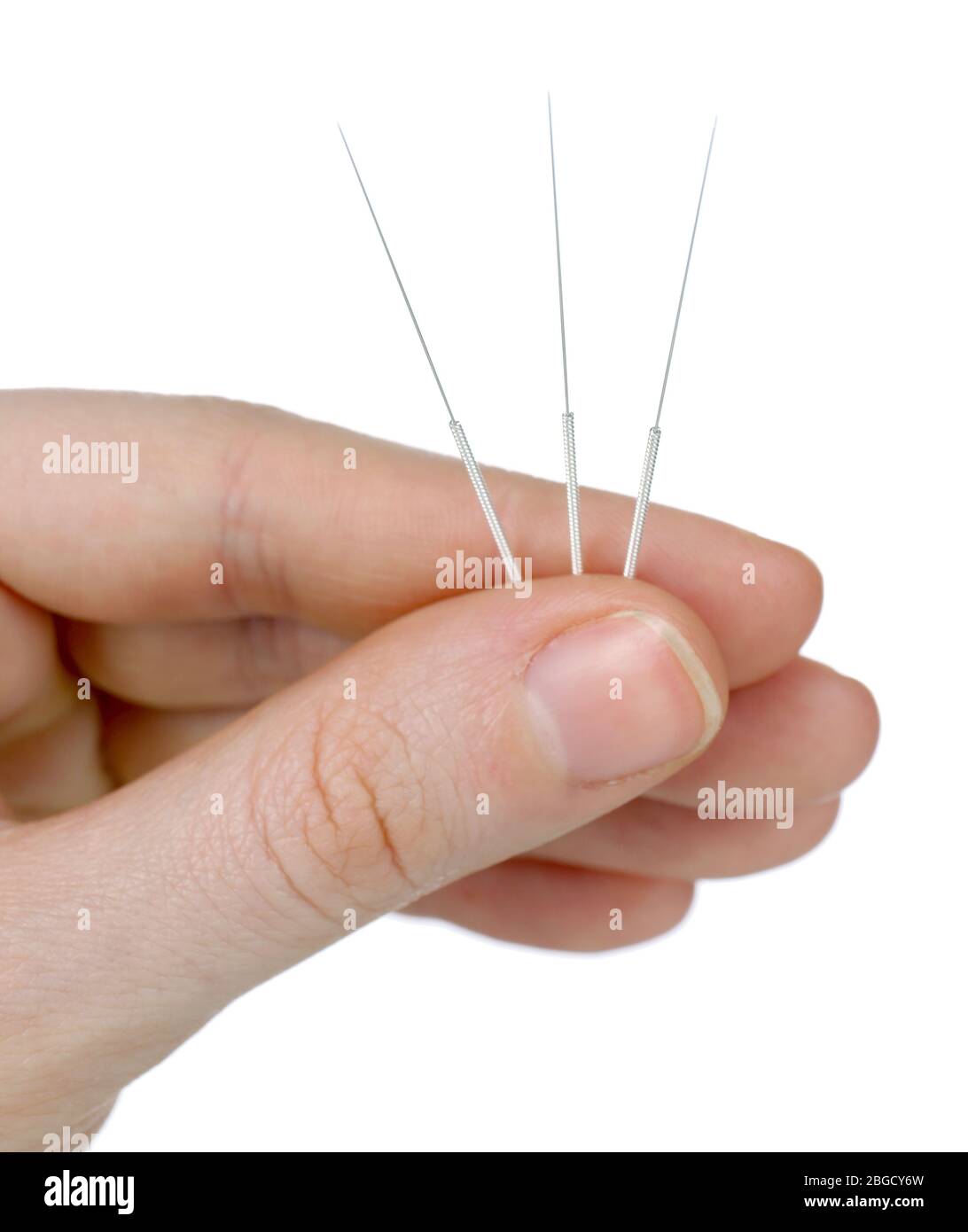 Hand holding needles for acupuncture on hand, close up. Isolated on ...