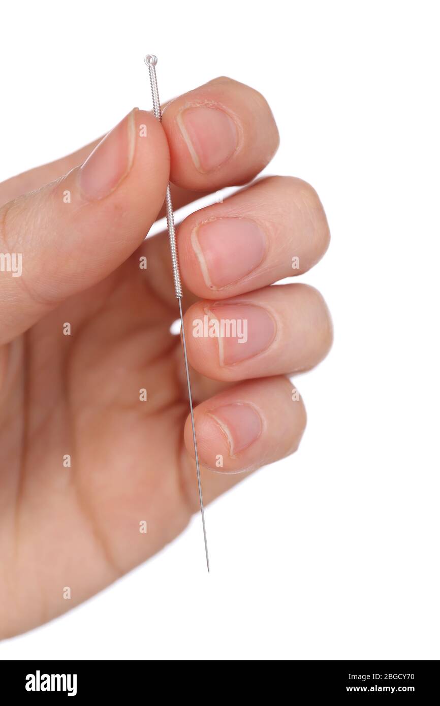 Hand holding needle for acupuncture on hand, close up. Isolated on ...