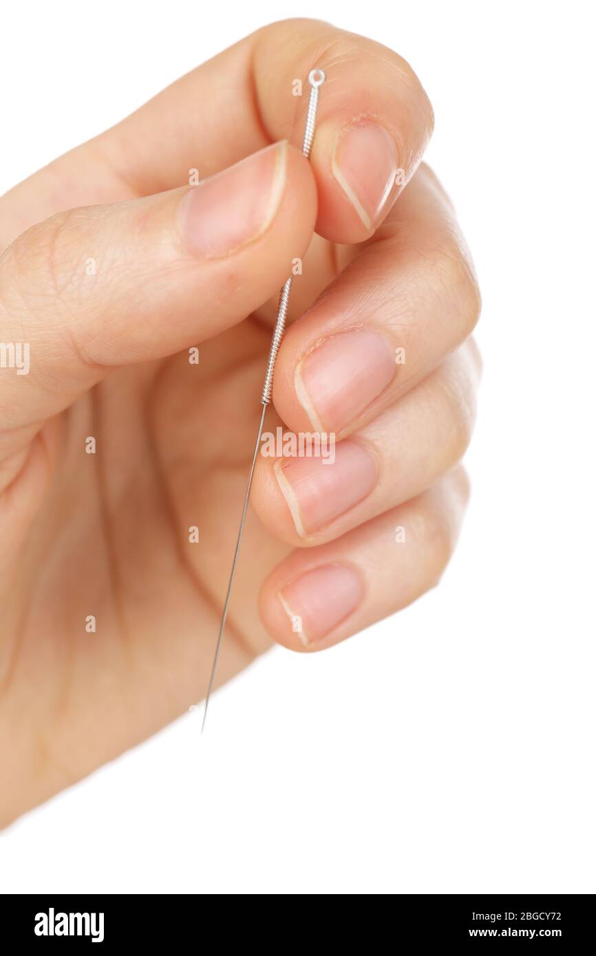 Hand holding needle for acupuncture on hand, close up. Isolated on ...