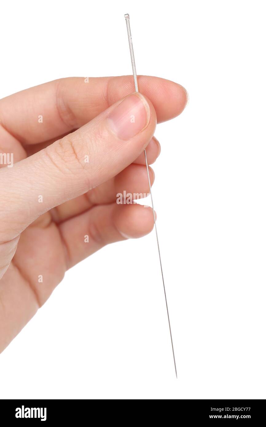 Hand holding needle for acupuncture on hand, close up. Isolated on ...